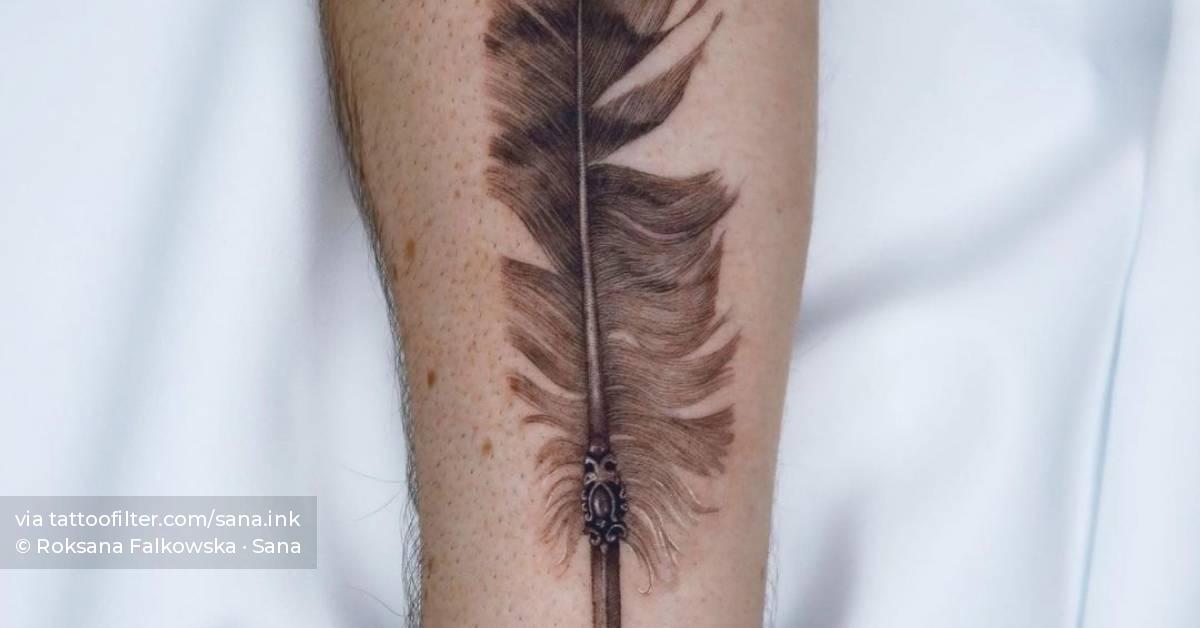 Black and grey quill tattoo located on the inner