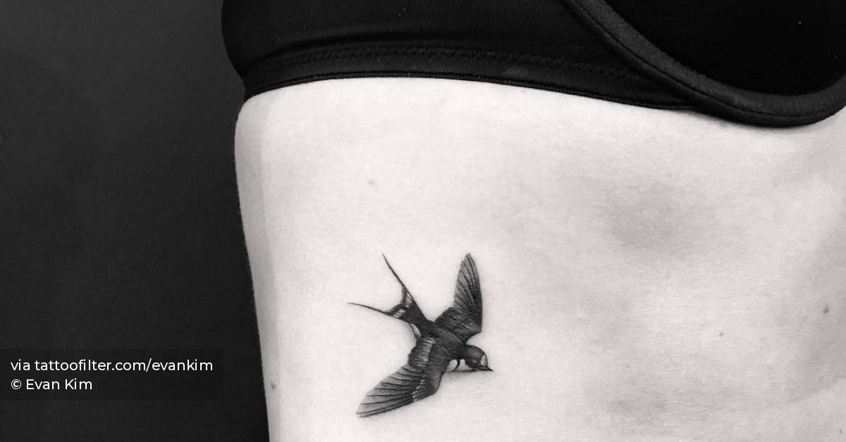 Micro-realistic style swallow tattoo located on the