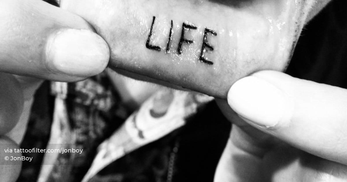 Tattoo of the word "life" located on the inner lip.