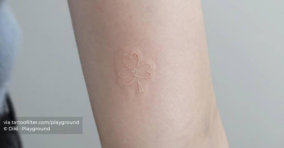 Little clover tattoo in white ink located on the inner