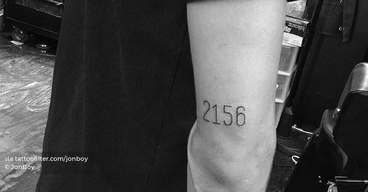 Tattoo of the number "2156" located on the tricep.