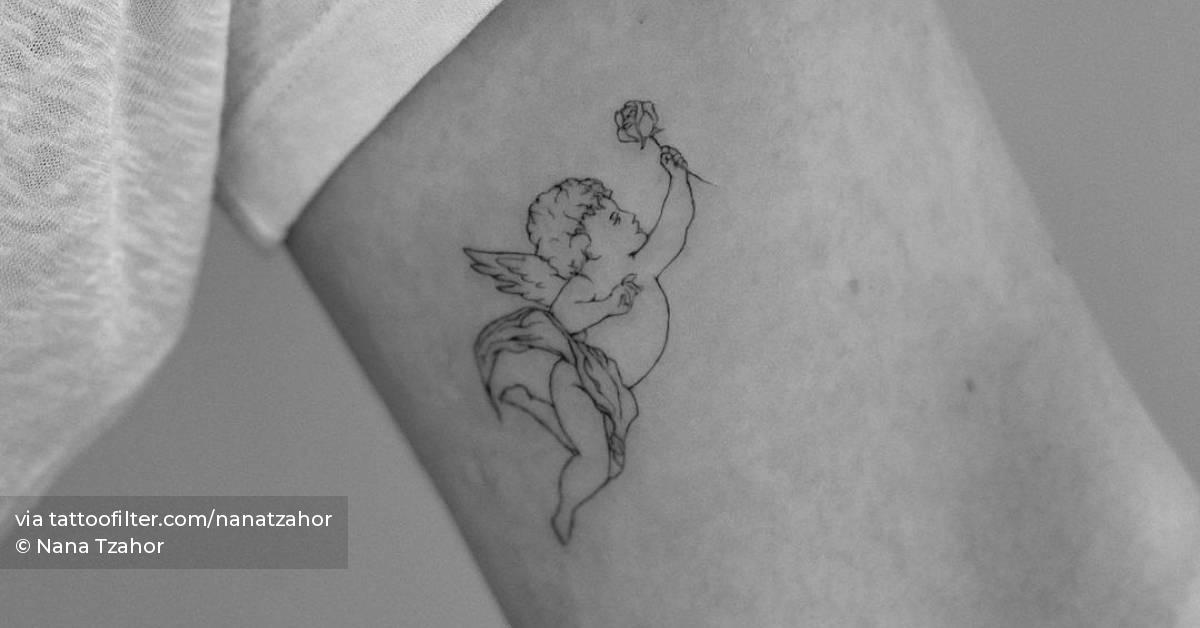 Fine line style cherub tattoio located on the inner