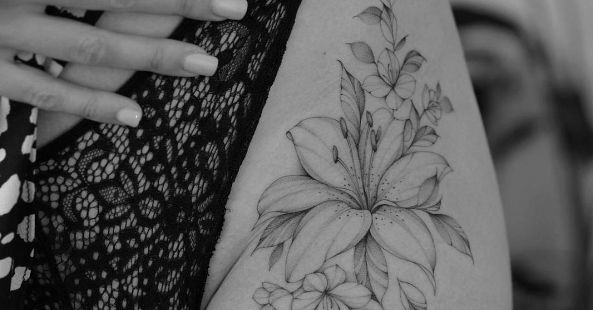 Lily flower tattoo located on the hip
