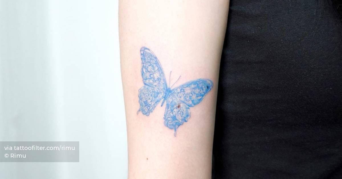 Blue butterfly tattoo placed on the bicep.