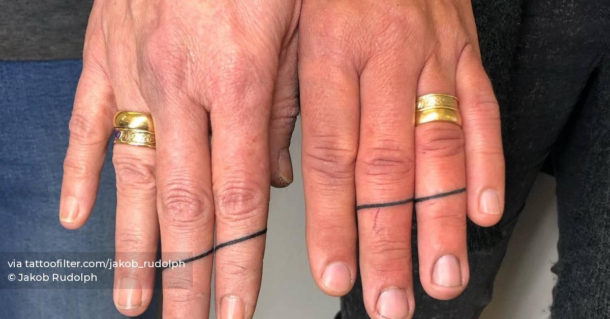 Matching minimalistic lines tattooed on couple.