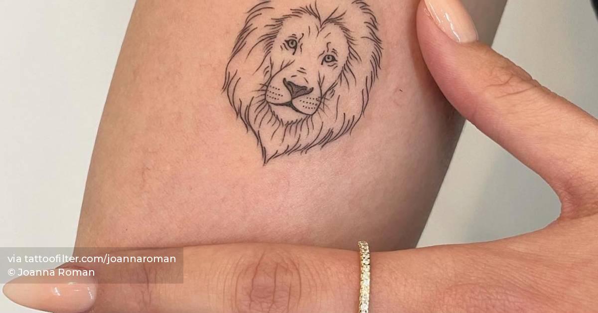 Fine line lion portrait tattoo located on the inner