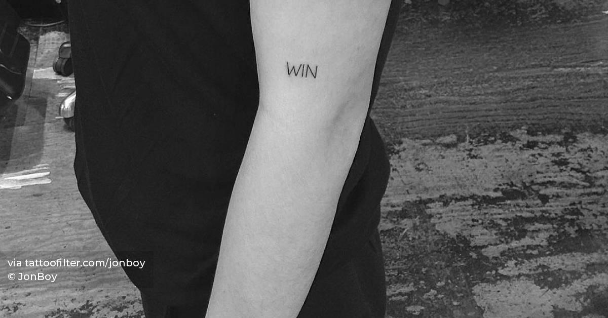 Tattoo of the word "win" located on the upper arm.