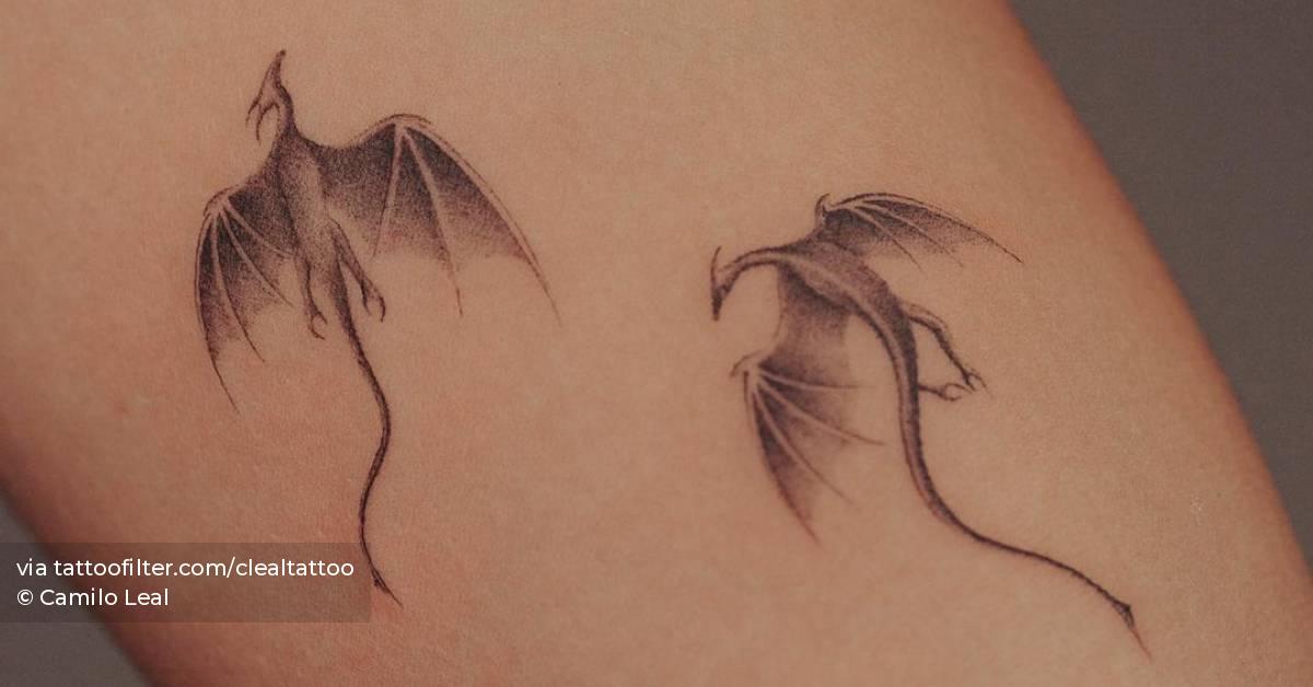 Tiny dragons tattooed on the inner arm.