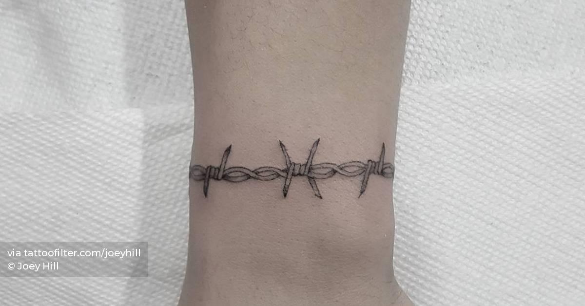 Barbed wire wristband tattoo.