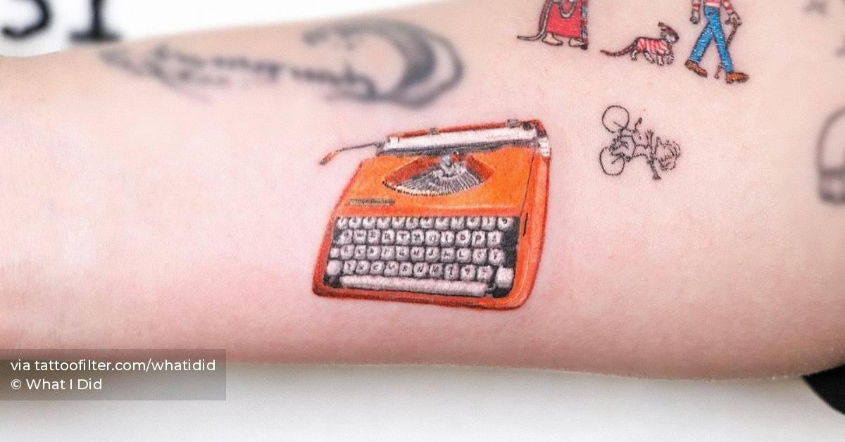 Micro-realistic style typewriter tattoo located on the