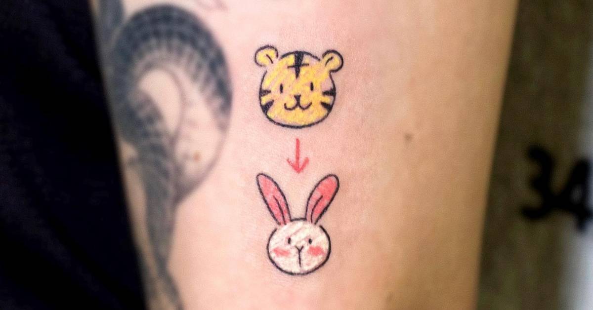 Minimalistic tiger and rabbit portrait tattoo located