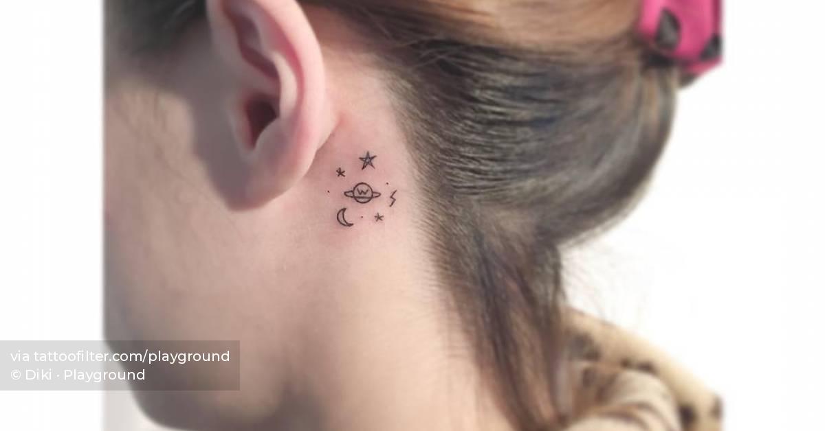 Minimalistic galaxy tattoo placed behind the ear.