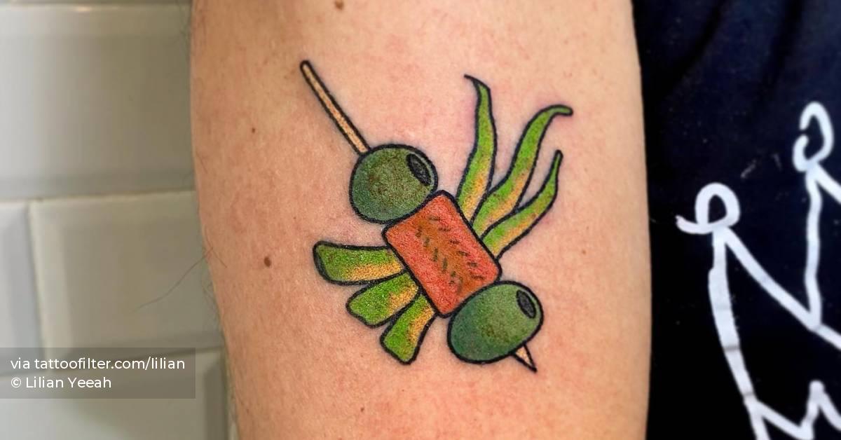 Gilda tattoo hand poked on the upper arm.