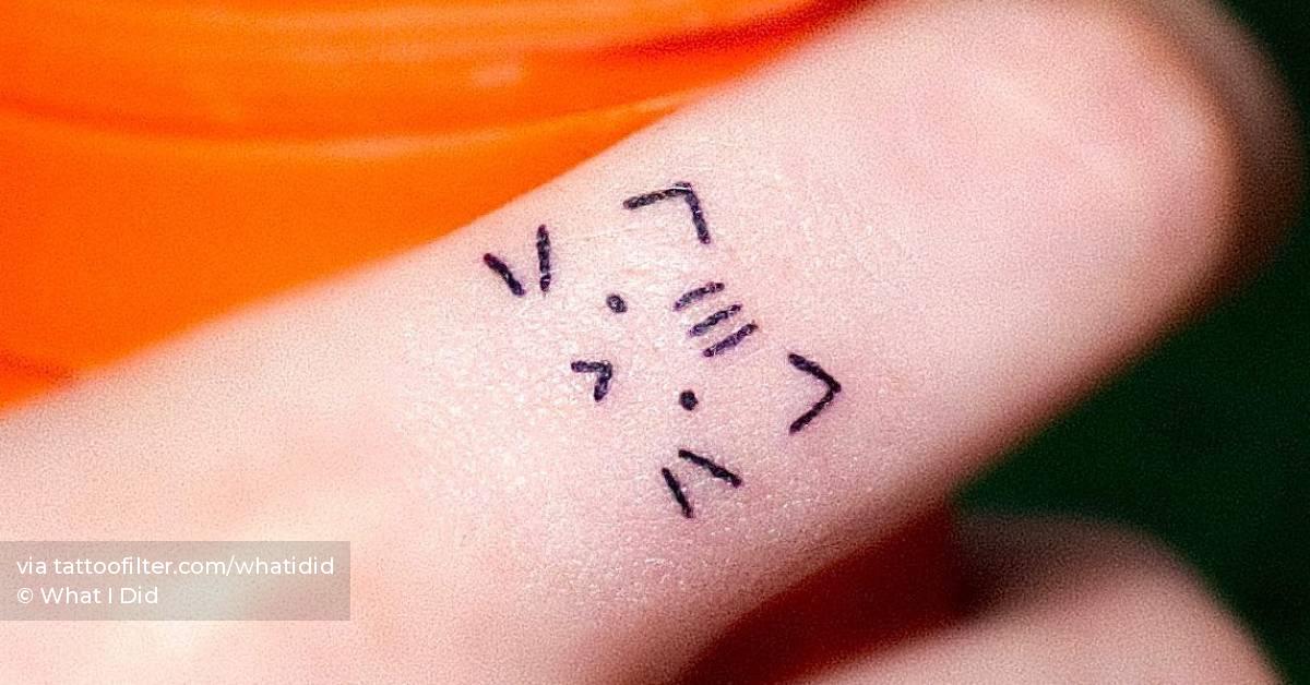 Cute minimalistic cat tattoo located on the finger.