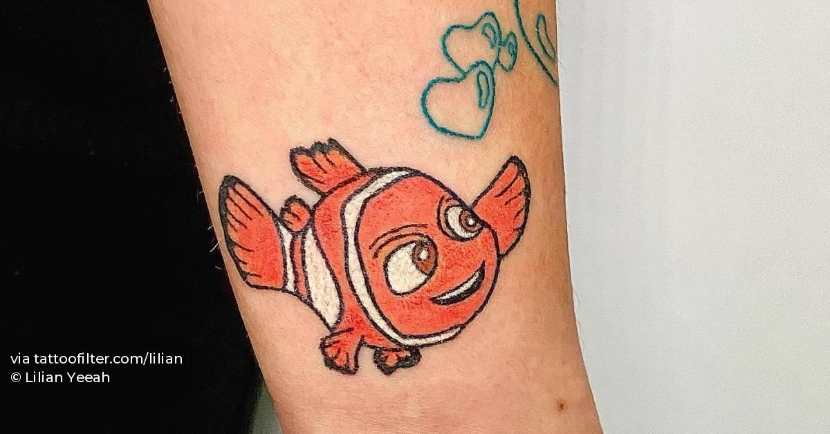Nemo tattoo hand poked on the wrist, cartoon style.
