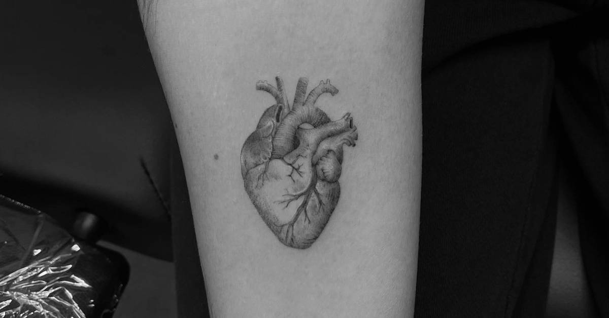 Micro-realistic style anatomical heart tattoo located