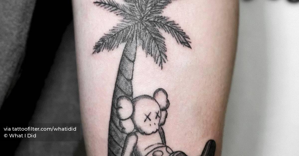 Kaws' artowrk tattooed on the inner forearm.