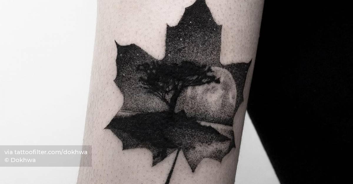 Maple leaf and landscape tattoo located on the tricep.