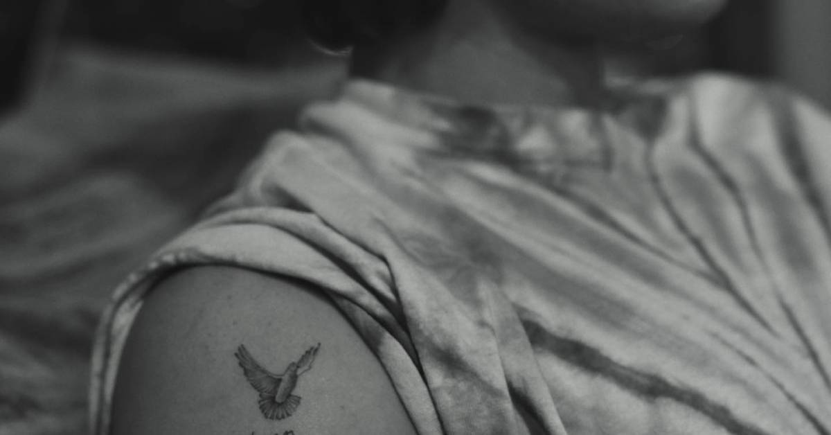 Healed dove tattoo located on Chase Stokes' shoulder.