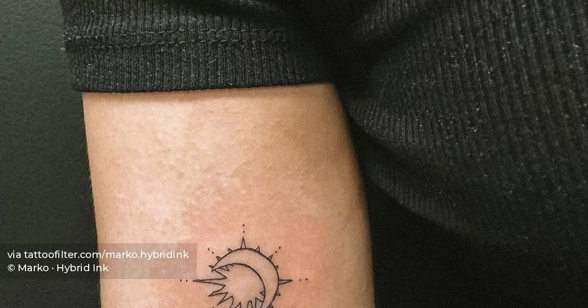 Minimalistic style eclipse tattoo located on the inner