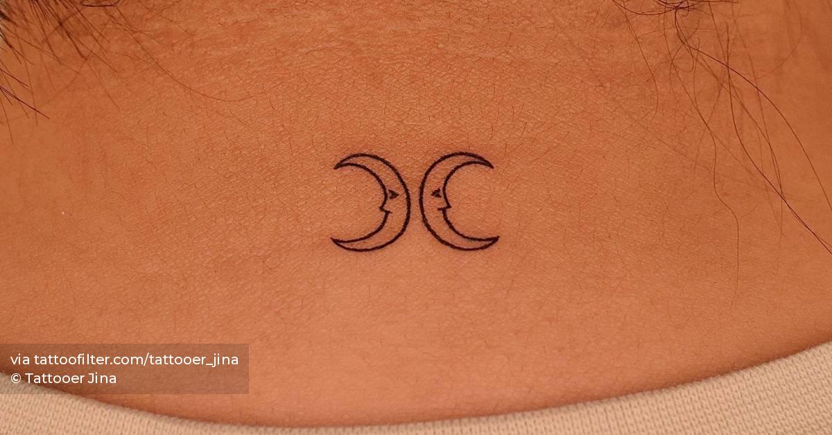 Minimalistic moon face tattoo located on the back of