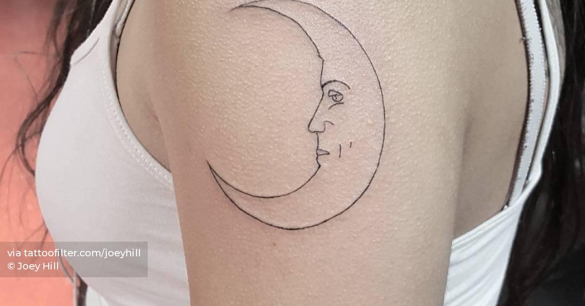 Moon face tattoo located on the upper arm, fine line