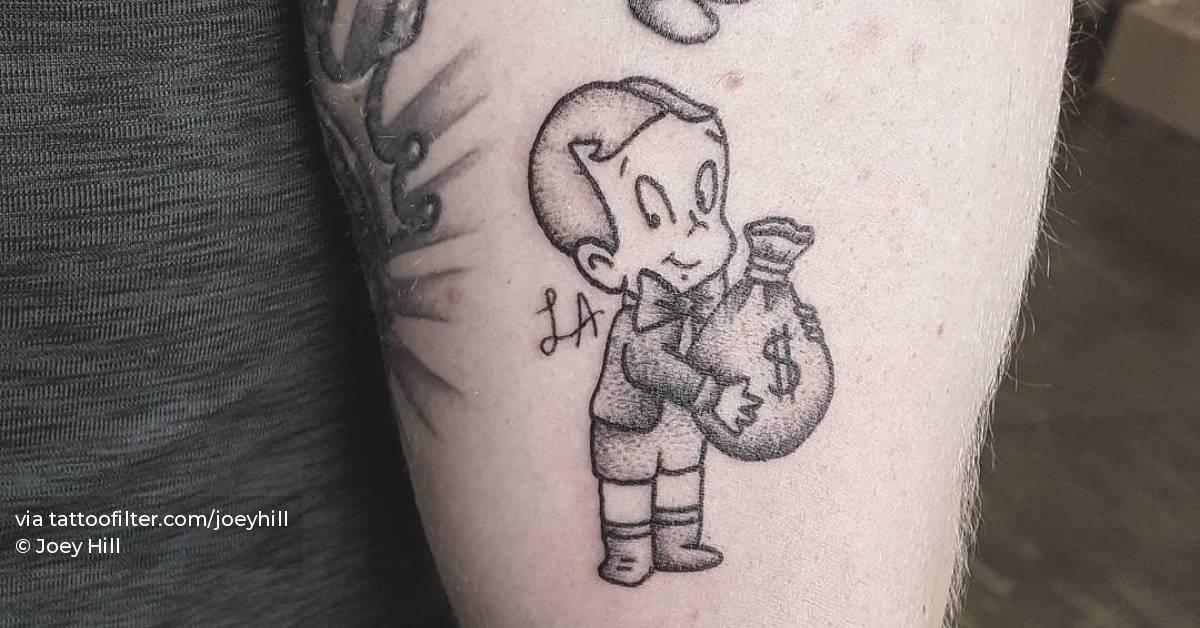 Richie Rich tattoo located on the upper arm.