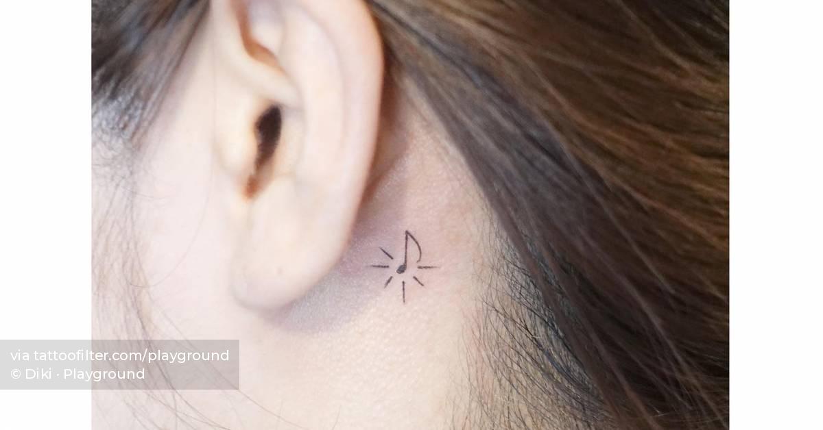 Minimalistic style quaver tattoo located behind the