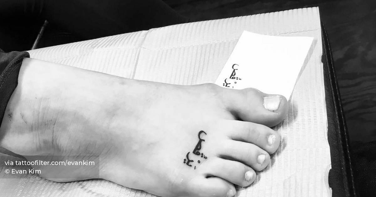 Arabic lettering tattoo located on the foot.