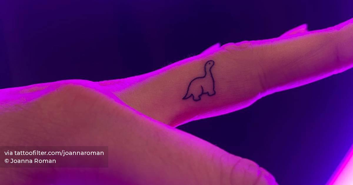 Tiny minimalistic diplodocus tattoo placed on the