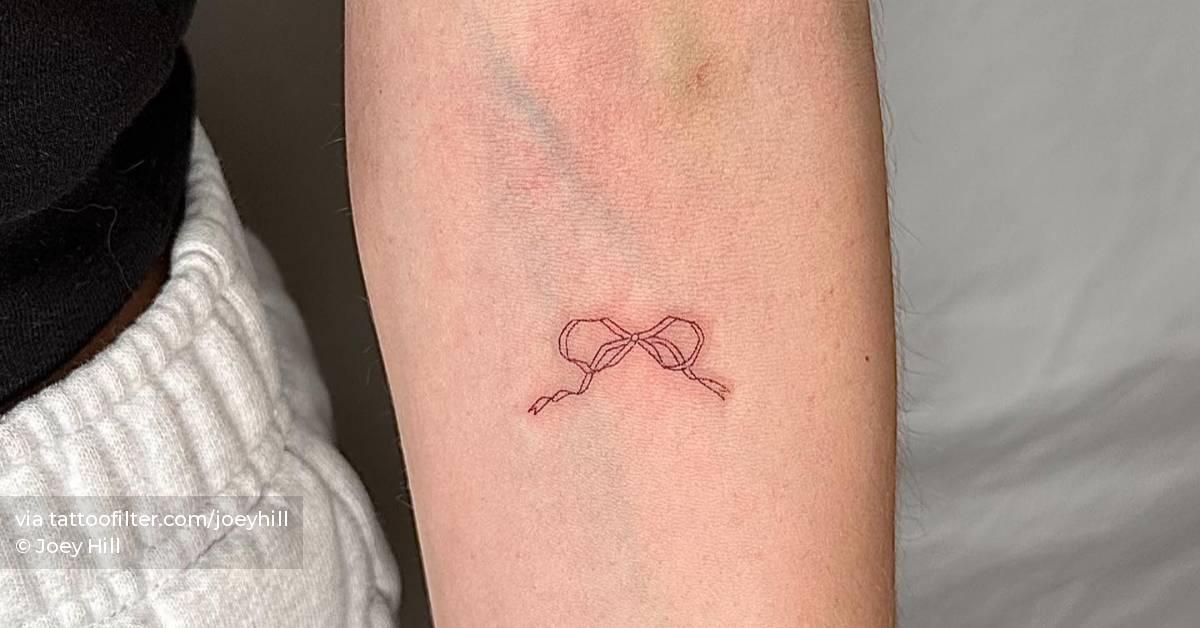 Single needle ribbon tattoo placed on the inner