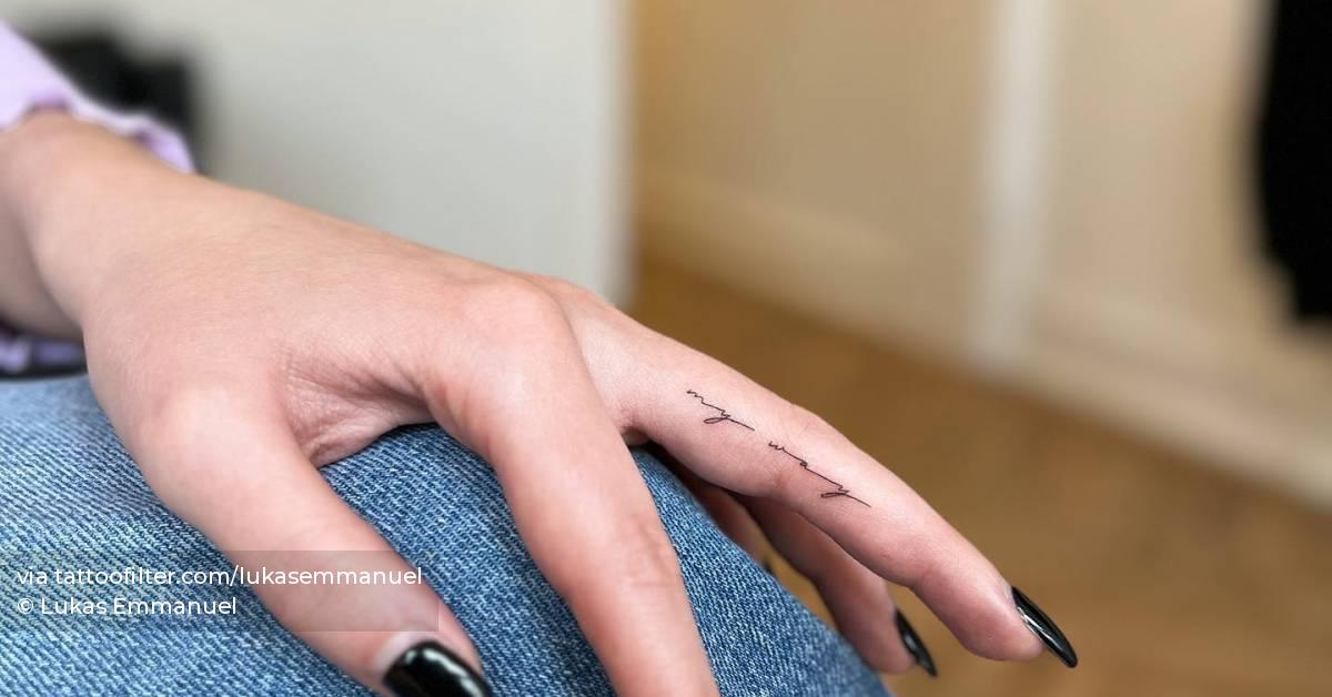 Tattoo that says "my way" handwritten on the finger.