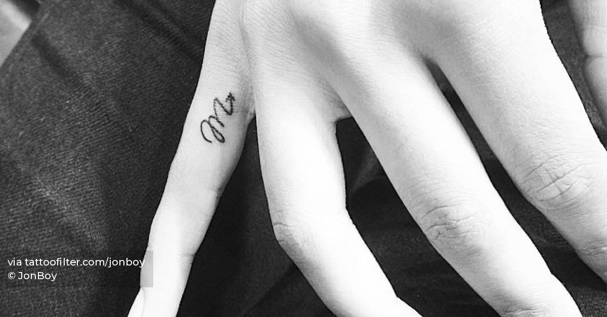 Scorpio symbol tattooed on the finger, minimalistic