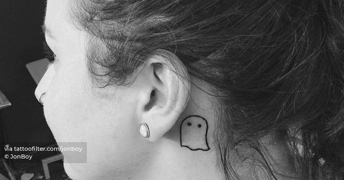 Minimalistic ghost tattoo placed behind the ear.