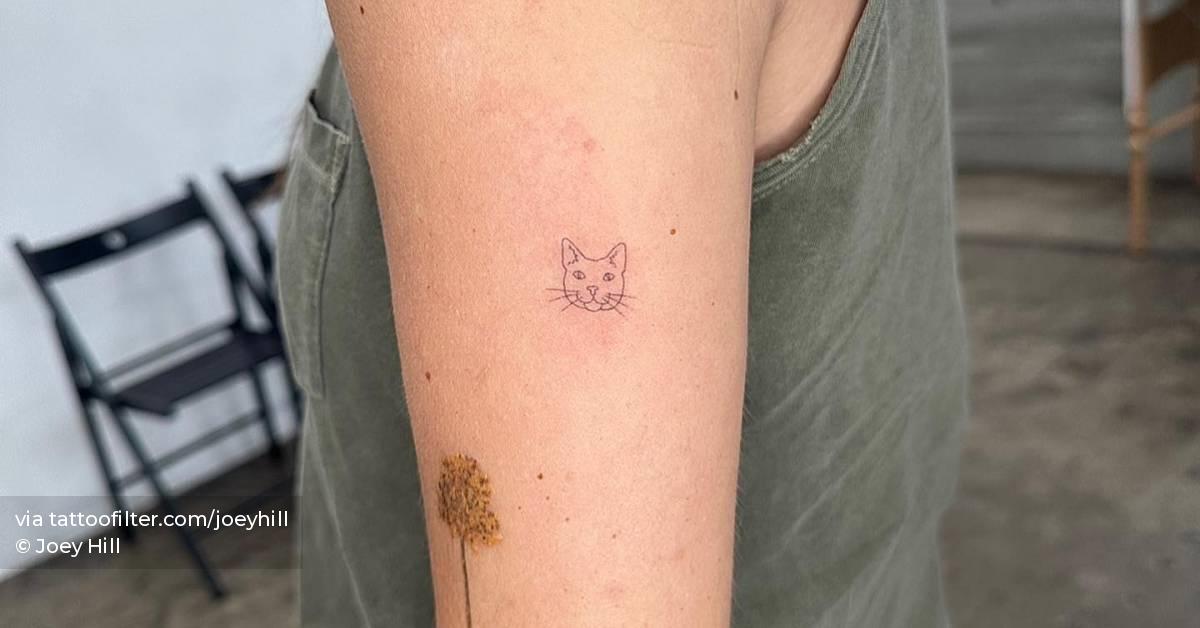 Fine line style cat portrait tattoo located on the