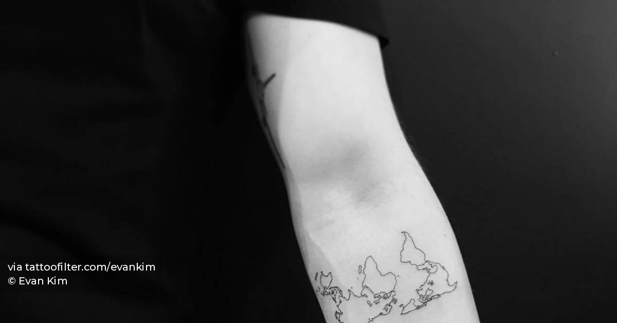 Fine line world map tattoo located on the inner arm.