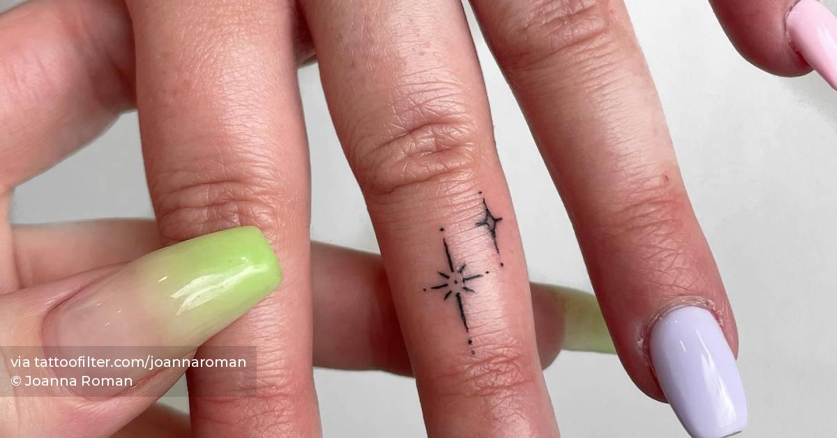 Minimalistic stars tattooed on the finger.