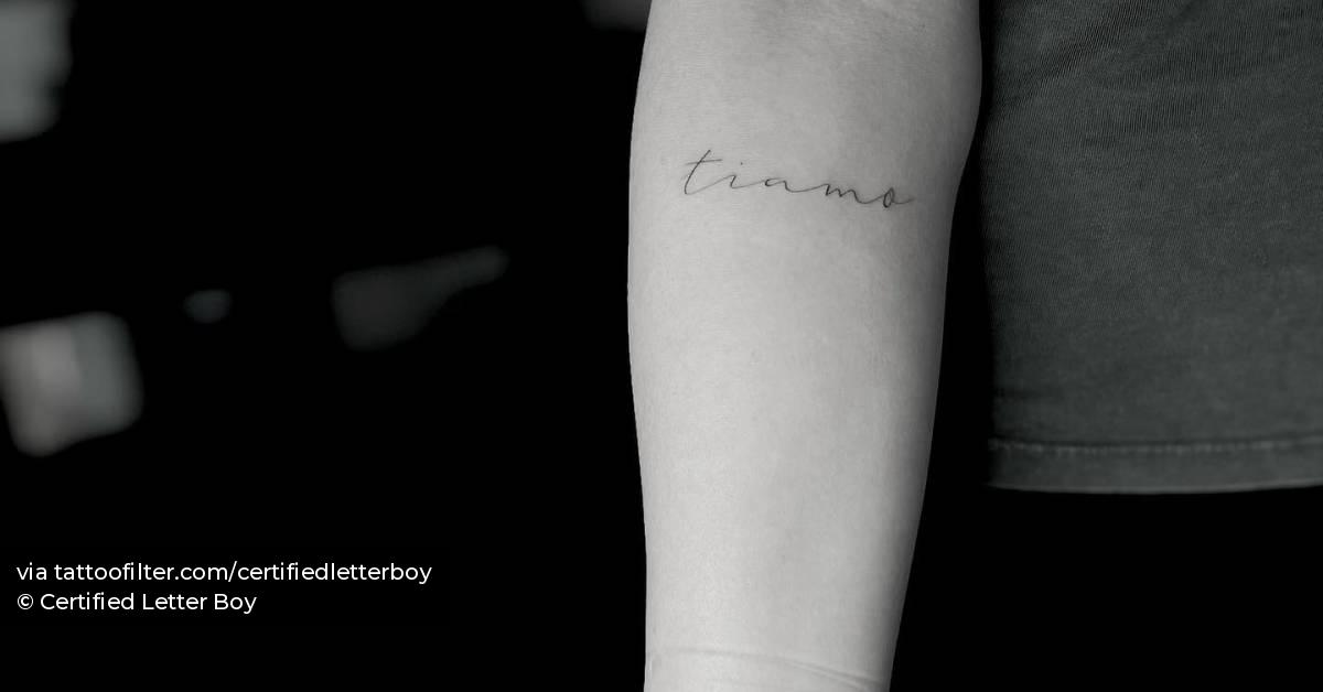 "Ti amo" lettering tattoo located on the inner forearm.