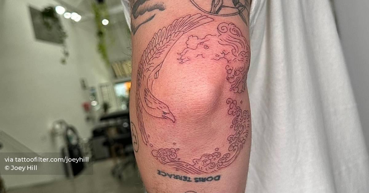 Fine line eagle and smoke tattoo located on the elbow.