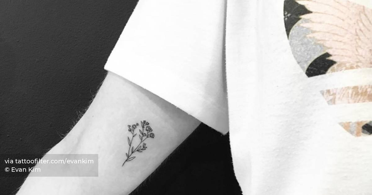 Fine line flower tattoo placed on the inner arm.