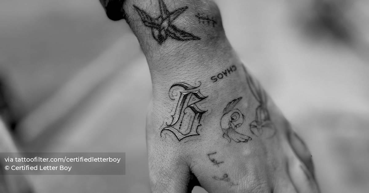 Letter "B" tattoo located on the hand.