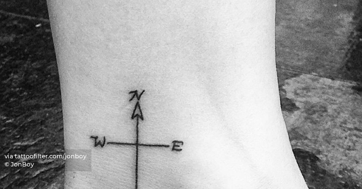 Minimalistic style compass rose tattoo located on the