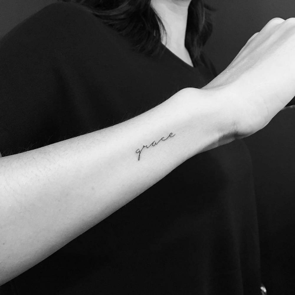 Tattoo Of The Word grace Handwritten On The Wrist 