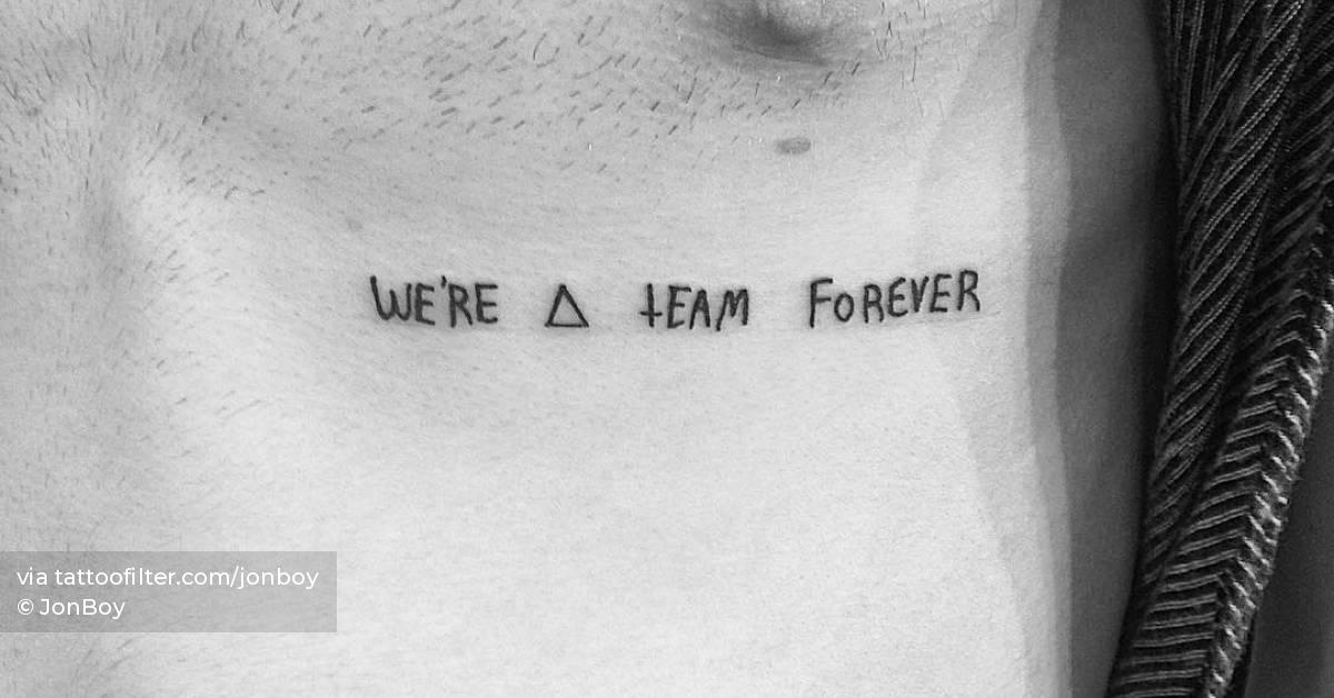 "We're a team forever" lettering tattoo located on the