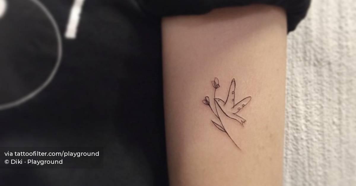 Minimalistic style dove and flower tattoo located on