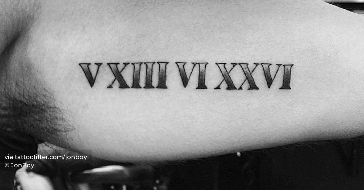 Roman numerals tattooed on the inner arm.