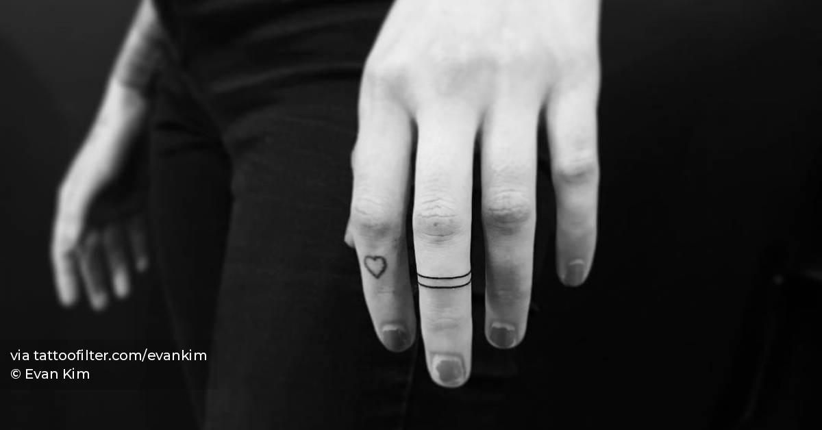 Minimalistic ring and heart tattoos located on the