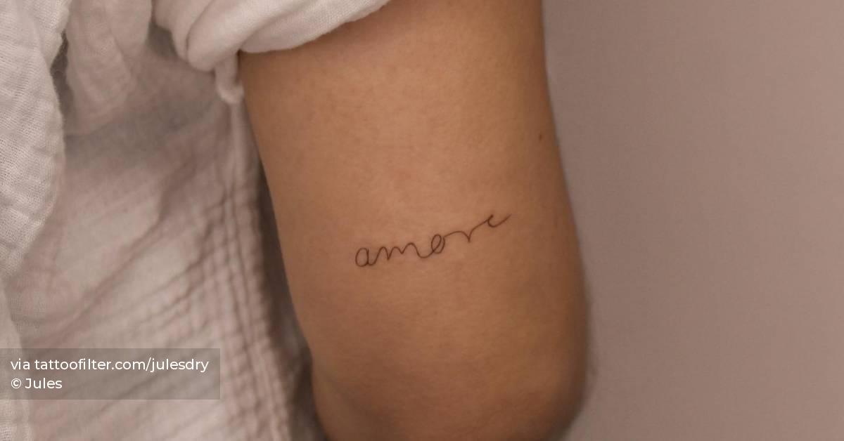 Tattoo of the word "amore" located on the tricep.