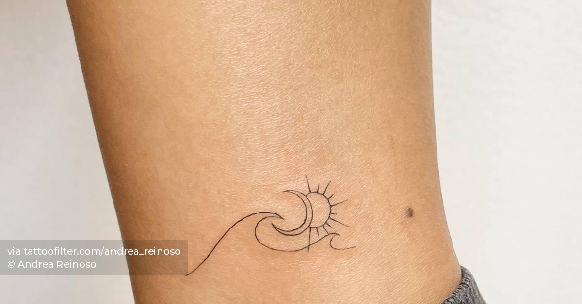 Wave, moon and sun tattoo located on the ankle.