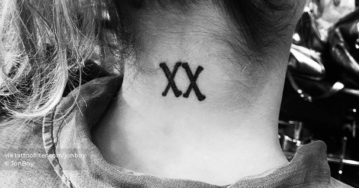 "XX" lettering tattoo located on the back of the neck.
